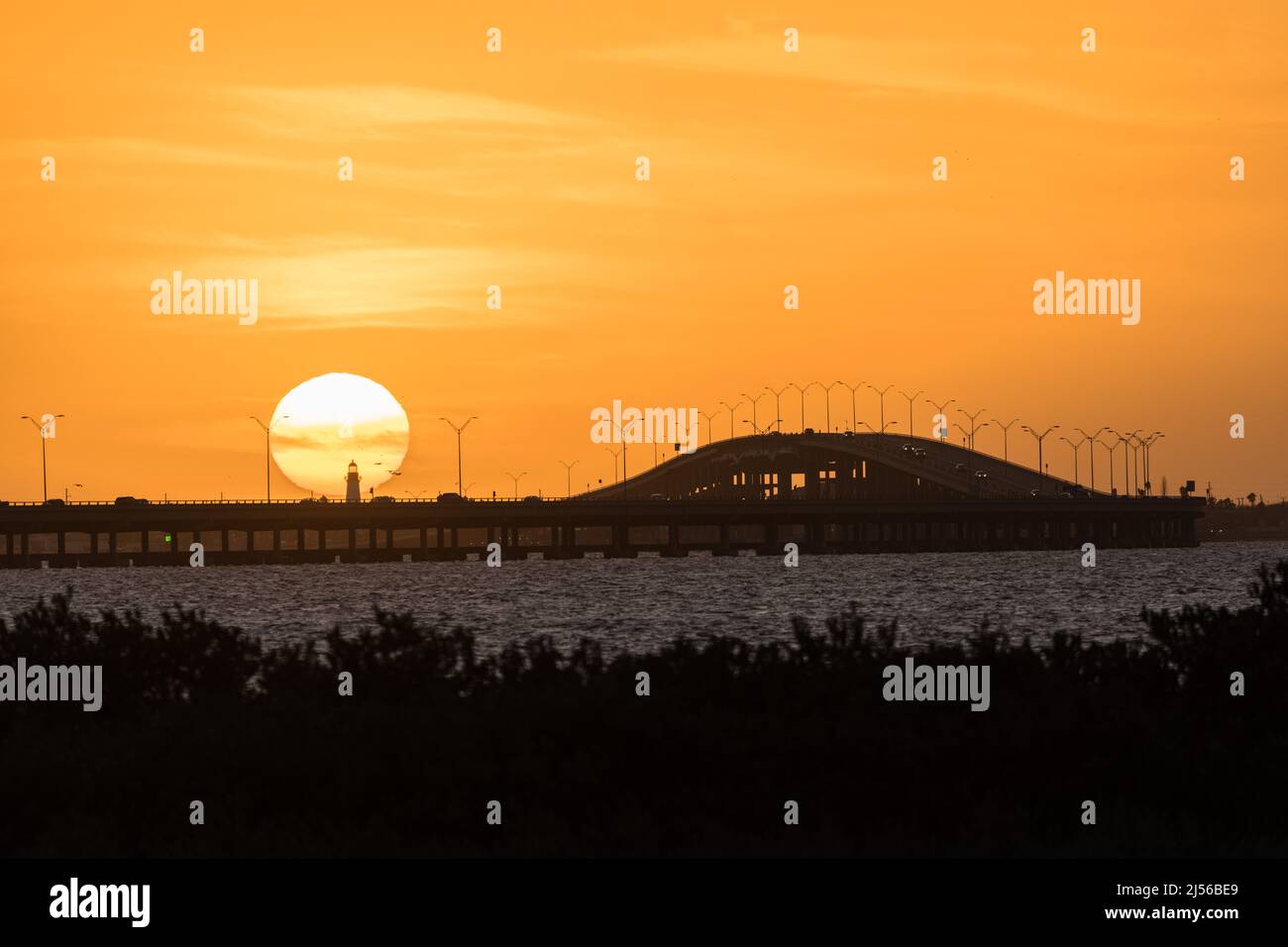 The Port Isabel Lighthouse in front of the setting sun with the Queen ...