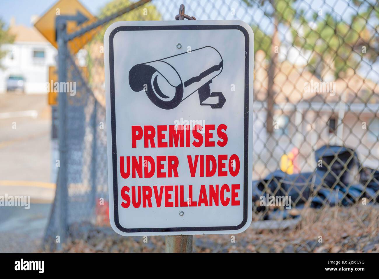 Premises under video surveillance signage on a mesh wire fence at San ...