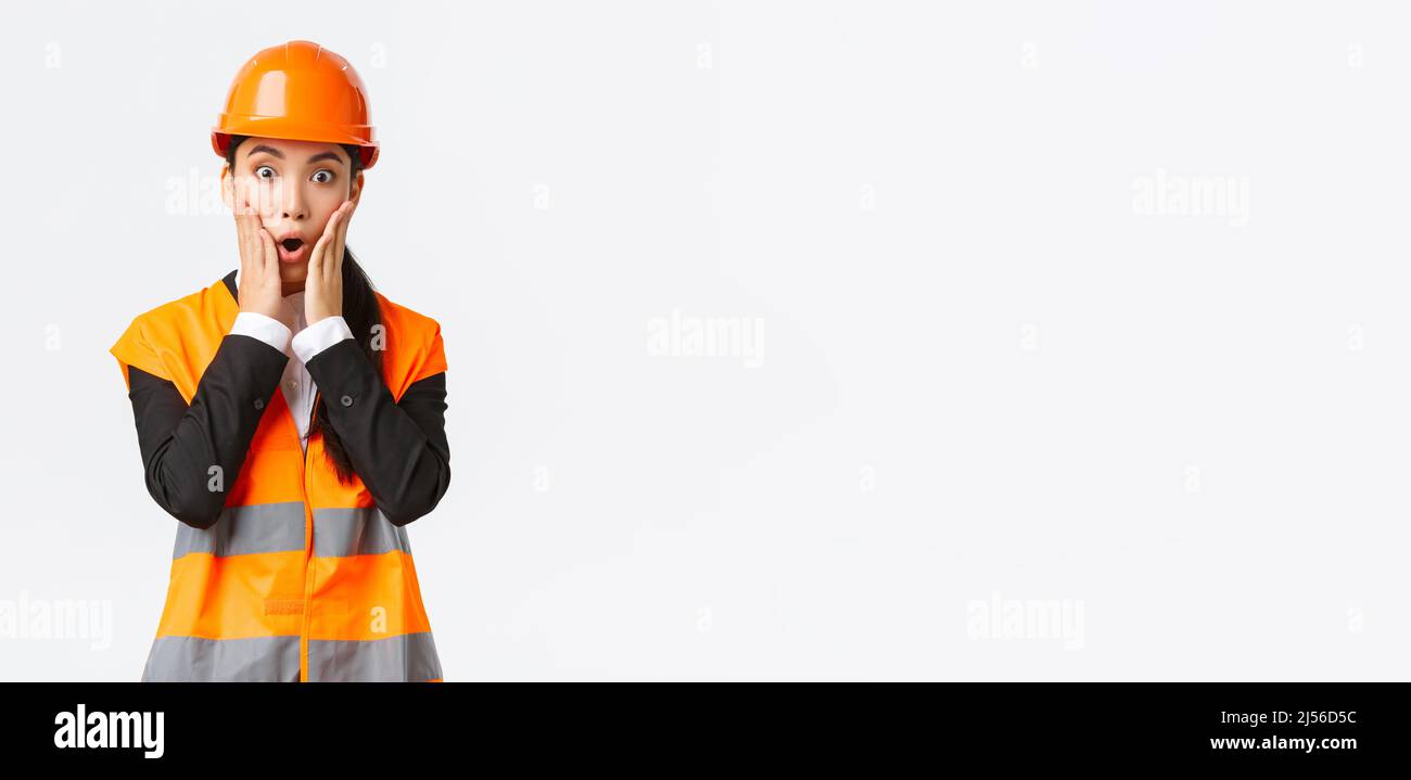 Shocked and concerned asian female engineer having problem at building ...