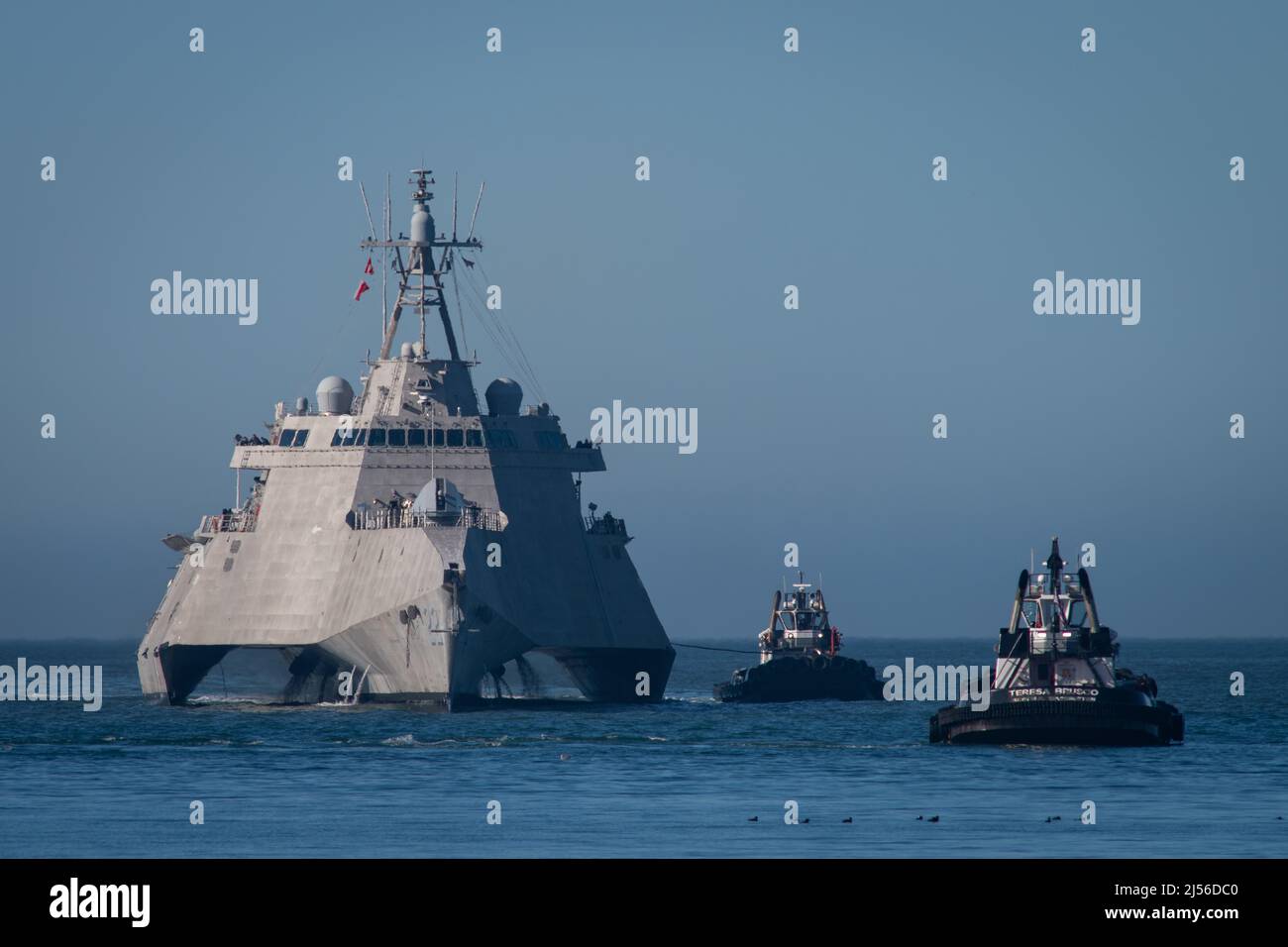 With assistance from two tugboats, USS Kansas City (LCS 22) glides into ...