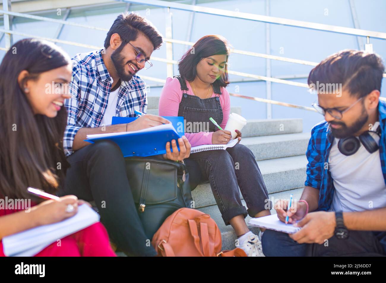 indian students keeping distance and do home work outdoors Stock Photo ...