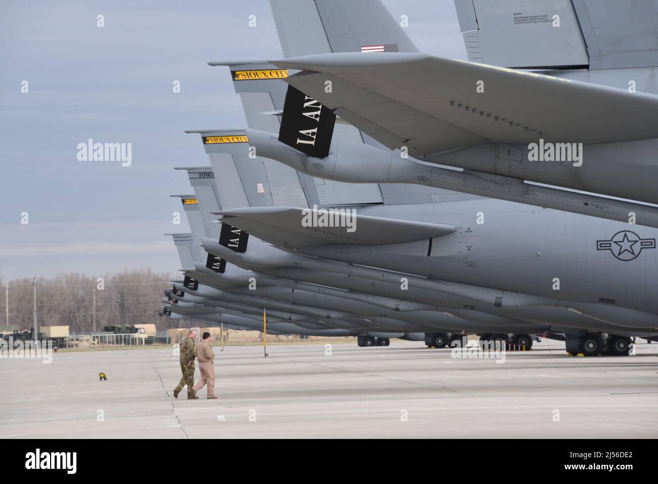 An Iowa Air National Guard pilot wearing a desert tan flight suit walks ...