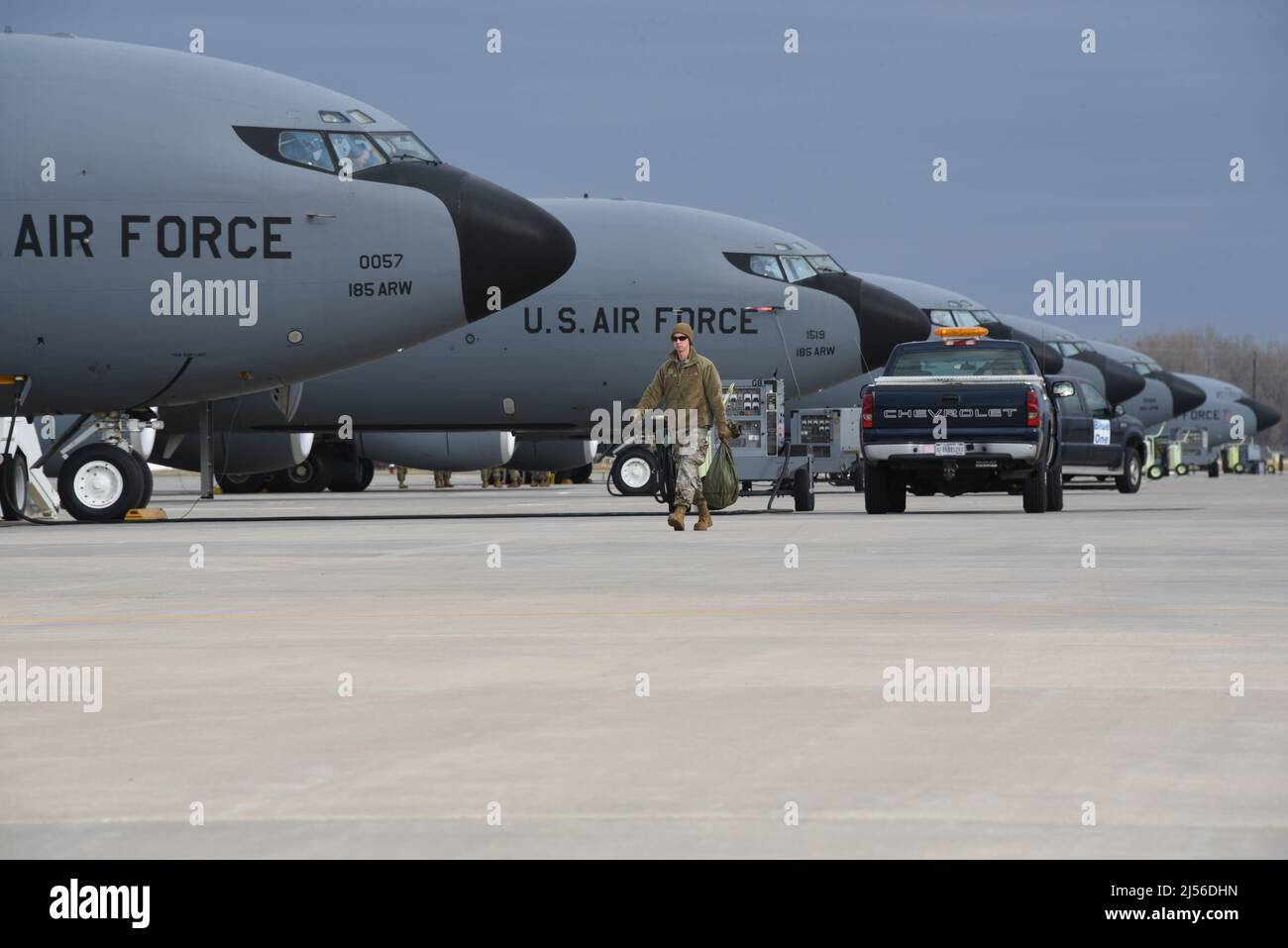 A crew chief from the Iowa Air National Guard walks along a row of U.S ...