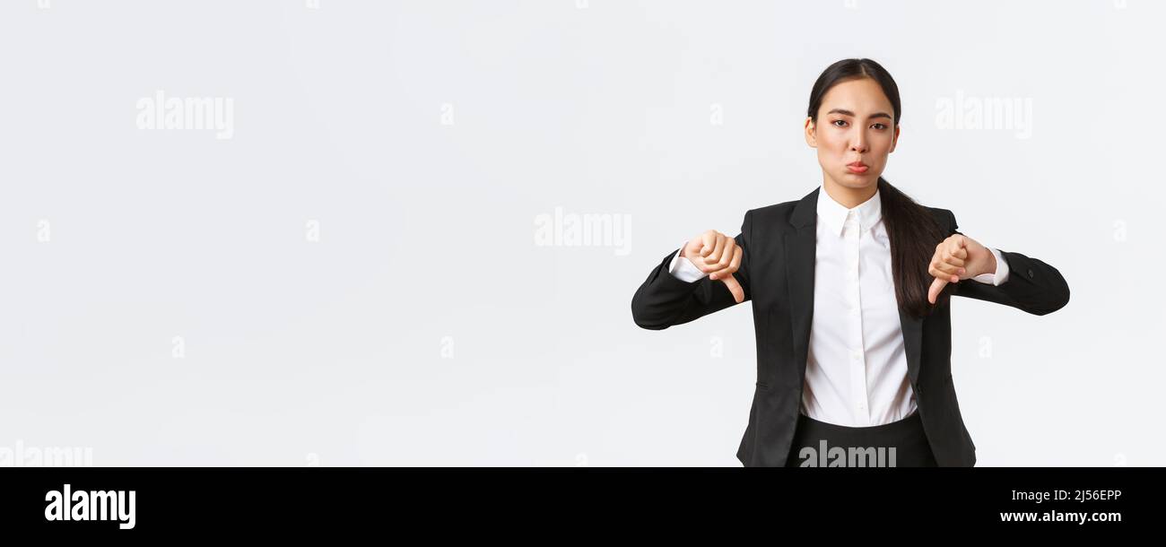 Unamused skeptical female office manager, saleswoman in black suit ...