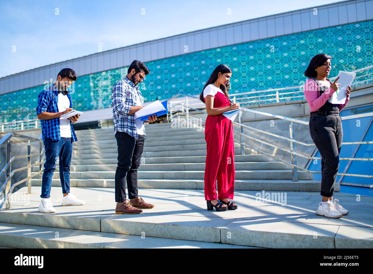 indian students keeping distance and do home work outdoors Stock Photo ...