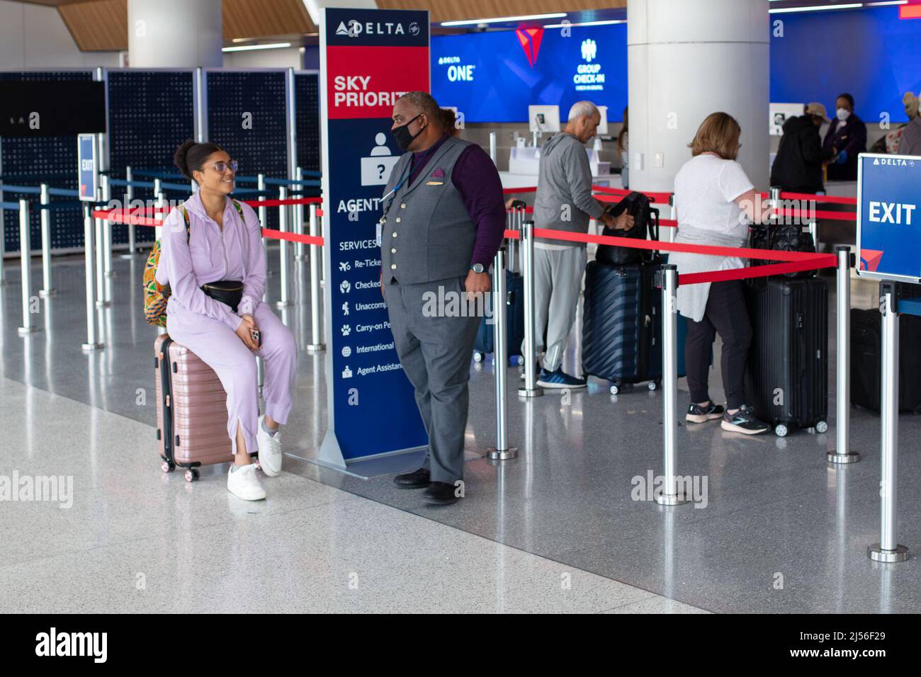 Los Angeles, CA April 20th: A Delta Agent chats with a customer as she ...