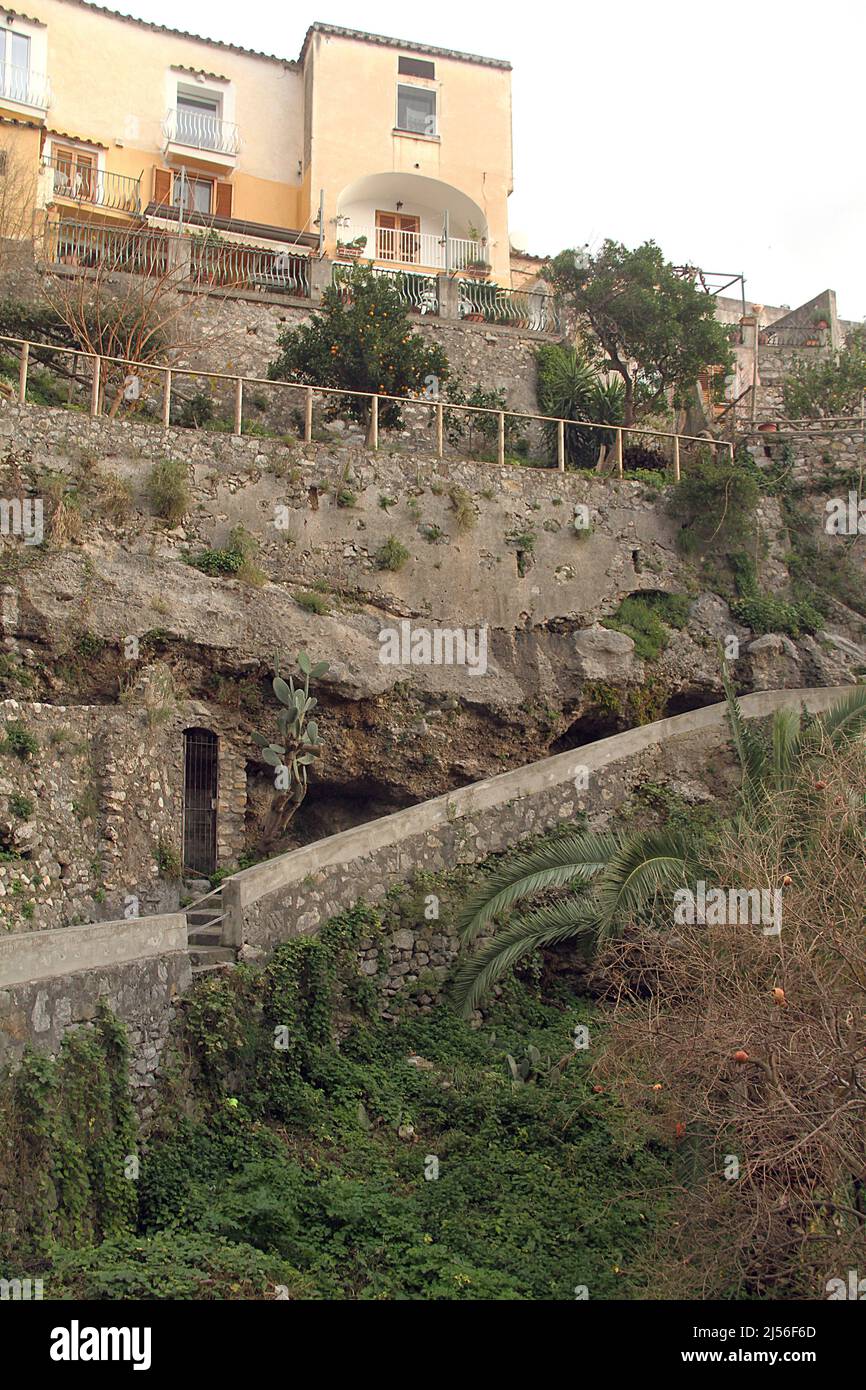 Building on a hillside in Positano, Italy. Retaining wall and path down ...