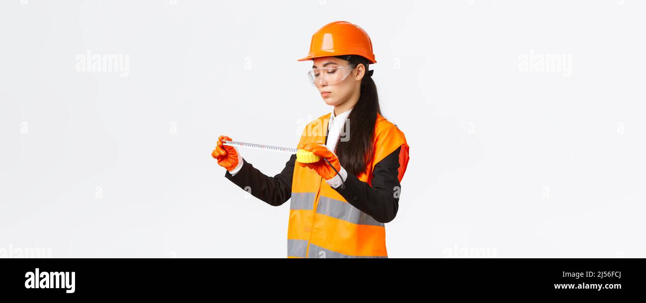 Serious asian female construction engineer, technician inspect layout ...