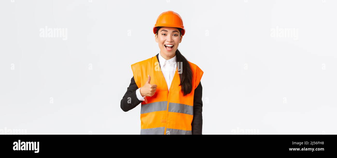 Supportive and pleased happy asian female chief engineer in safety ...