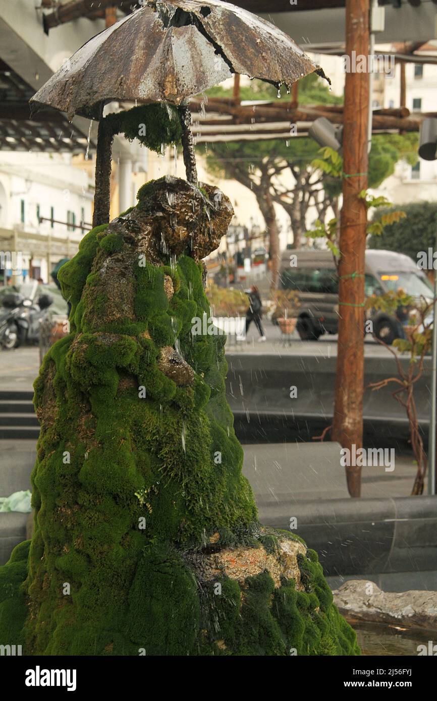 Moss-covered water fountain sculpture in Italy Stock Photo - Alamy