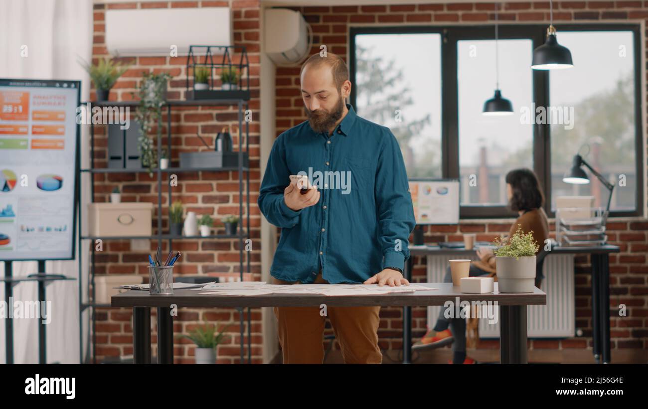 Nervous man checking time on watch and waiting important call to ...