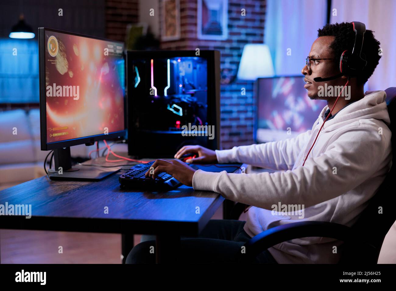 Cheerful person live streaming shooter video games on computer ...