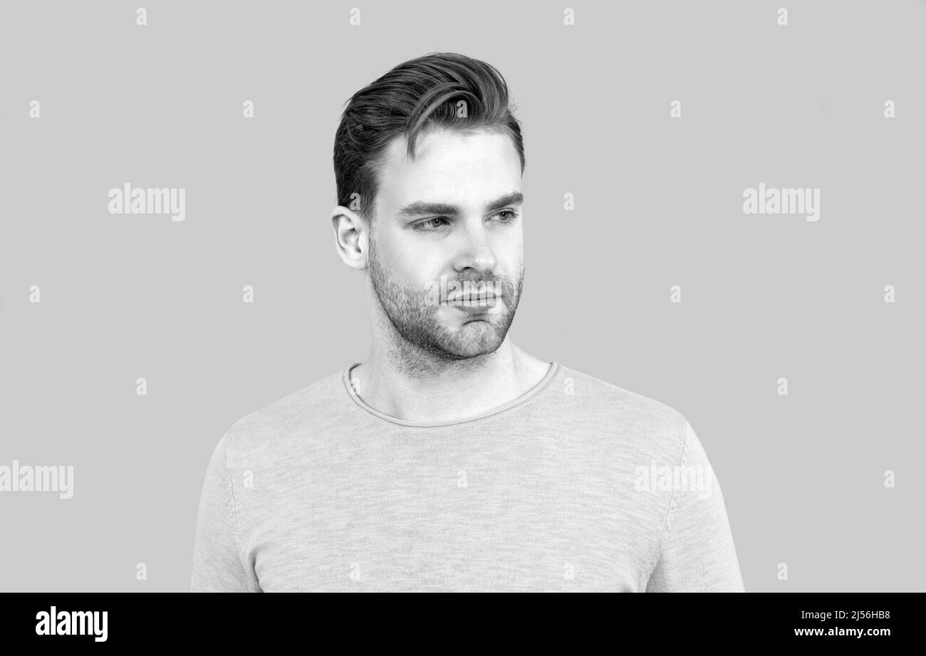 Good-looking young man portrait with unshaven face in yellow sweater ...