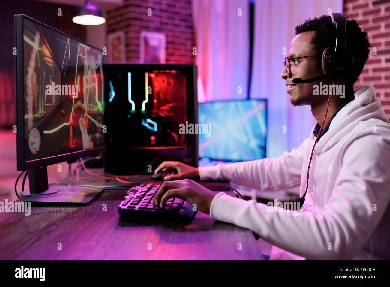 Modern happy man playing action video games on stream online, using ...