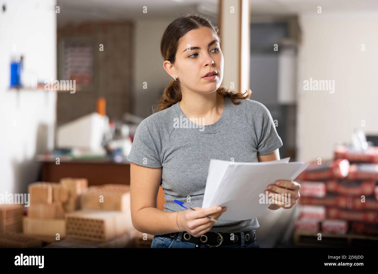 Female designer taking notes while planning apartment renovation Stock ...