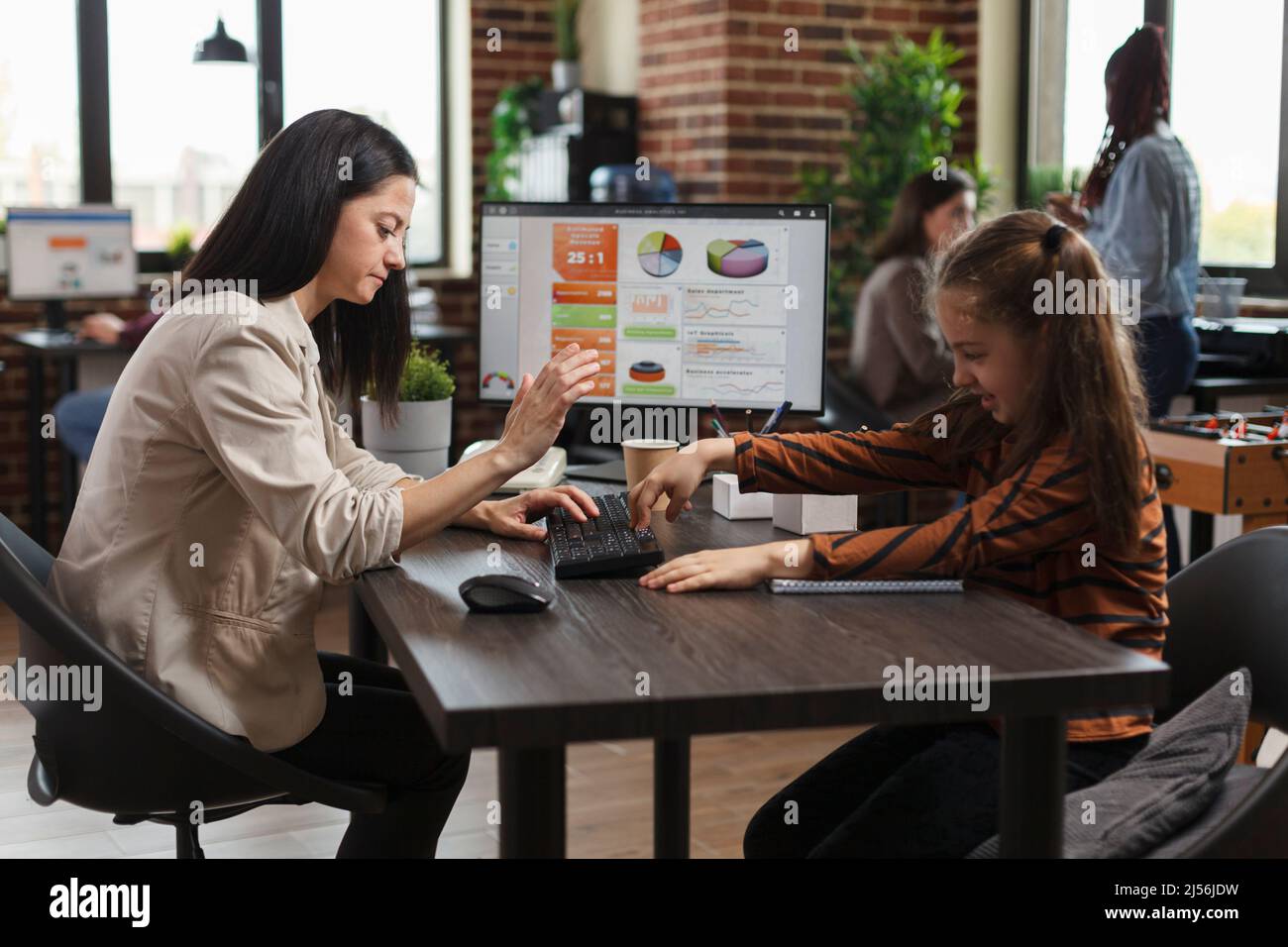 Full of energy little daughter pressing keyboard random keys while ...