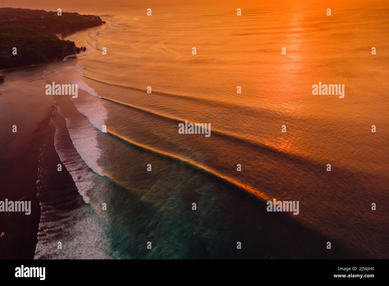 Aerial view of ideal line of waves at warm sunset. Perfect ocean wave ...