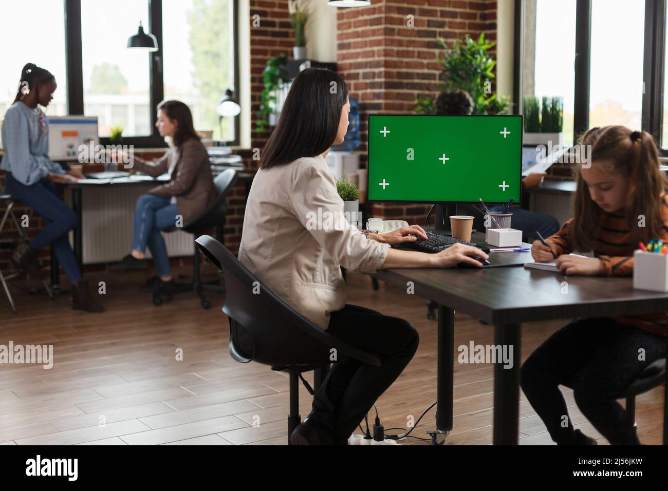 Working businesswoman using computer with blank chroma key template ...