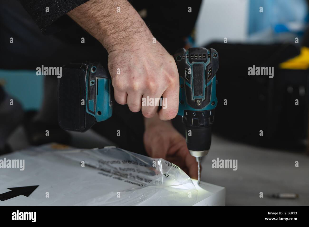 One unknown man caucasian male using electric cordless screwdriver ...