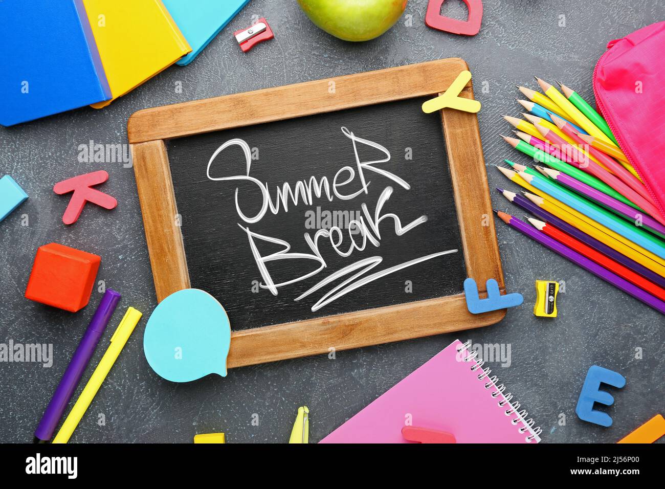 Chalkboard with text SUMMER BREAK and stationery on dark background ...