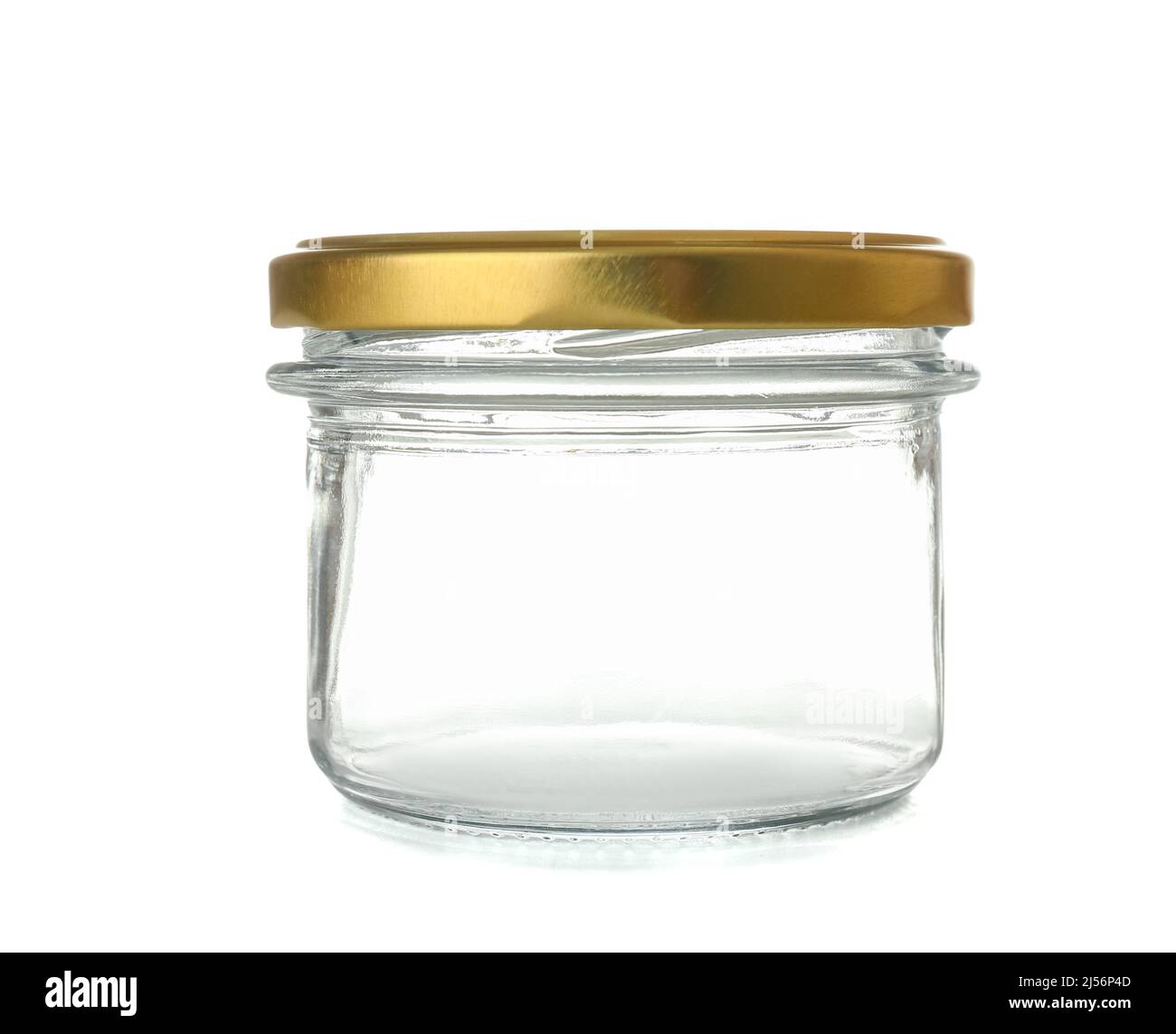 Glass jar with golden cap on white background Stock Photo - Alamy