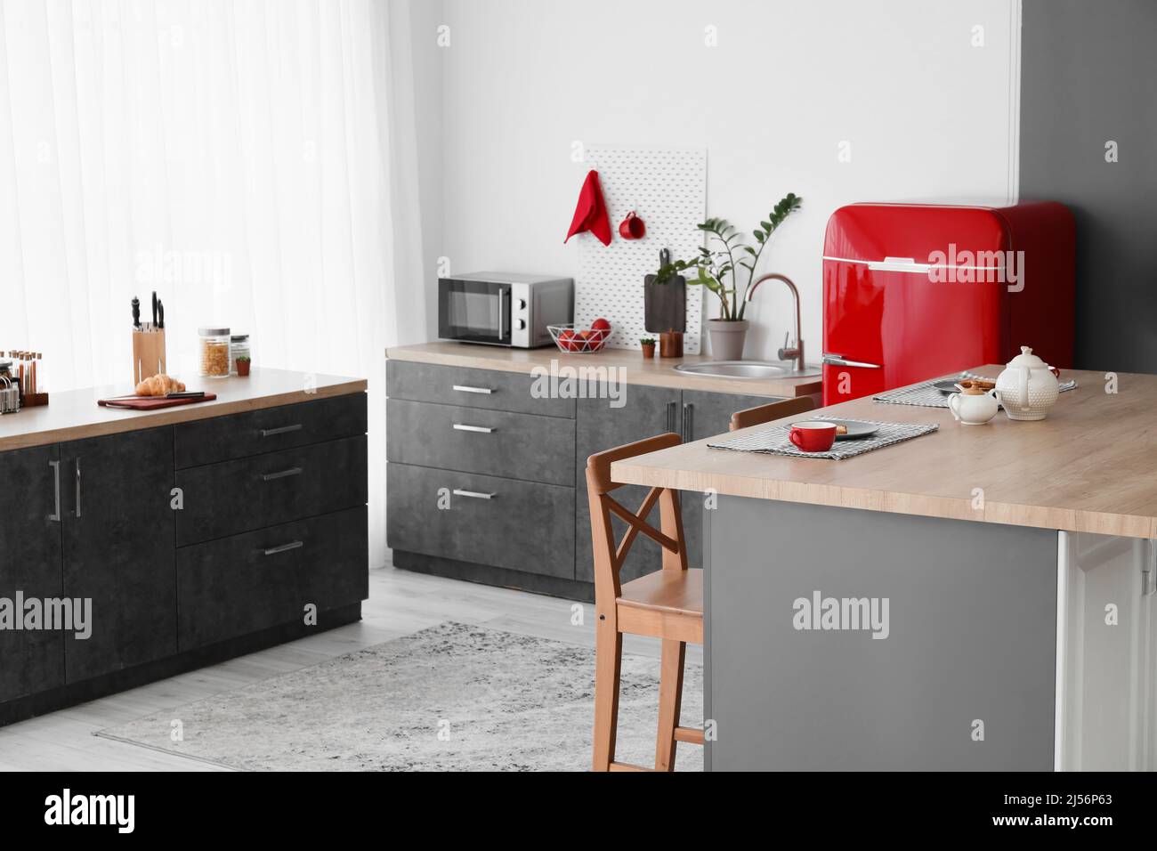 Interior of modern kitchen with red fridge, counters and pegboard Stock ...