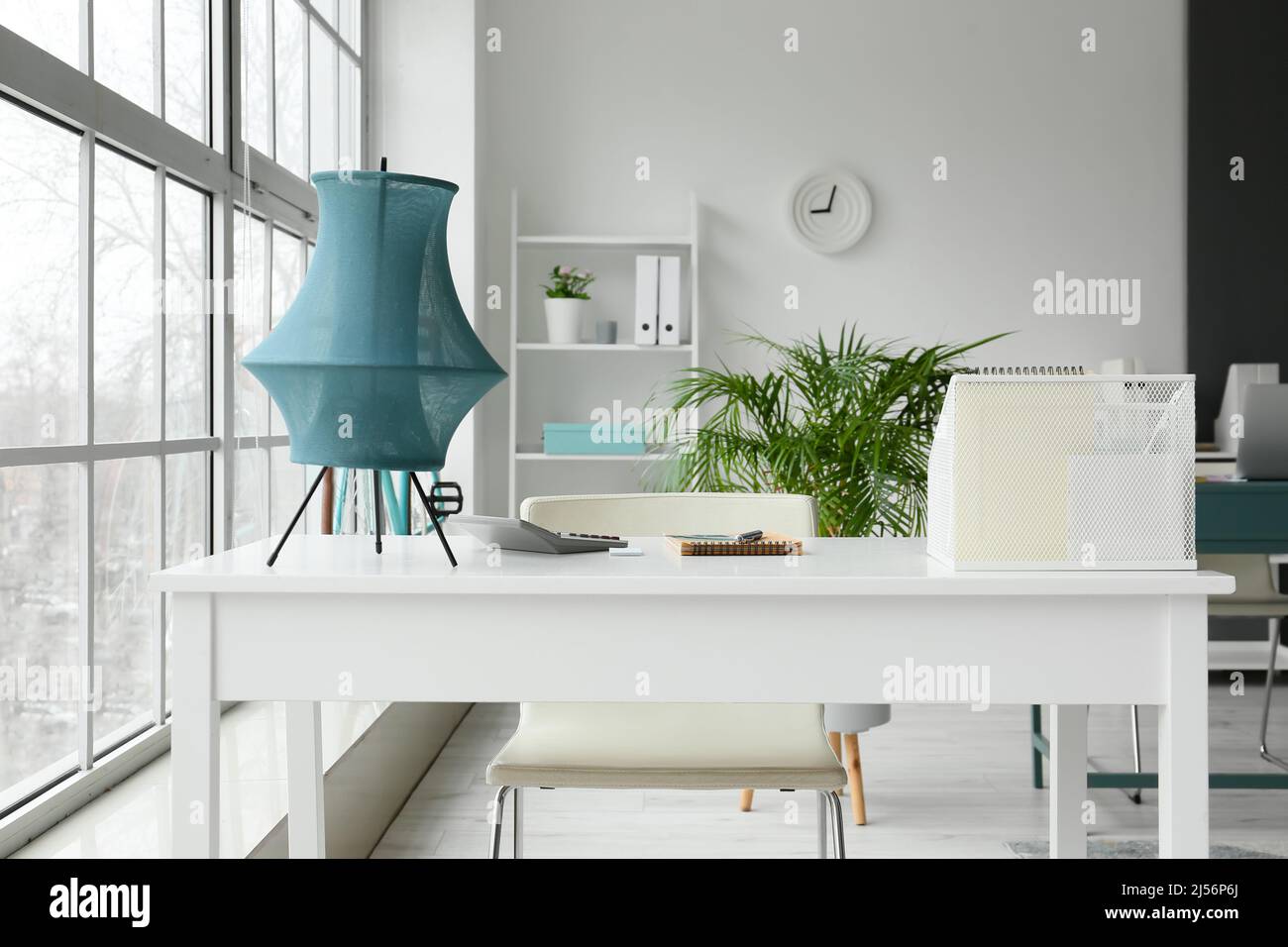 Modern workplace near big window in light office interior Stock Photo ...