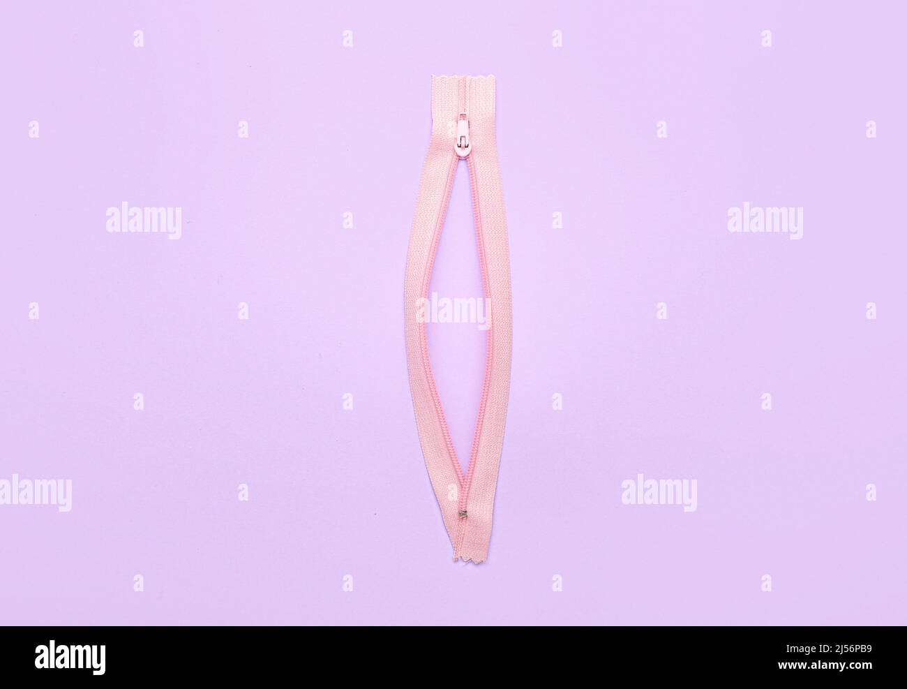 Stylish pink zipper on purple background Stock Photo - Alamy