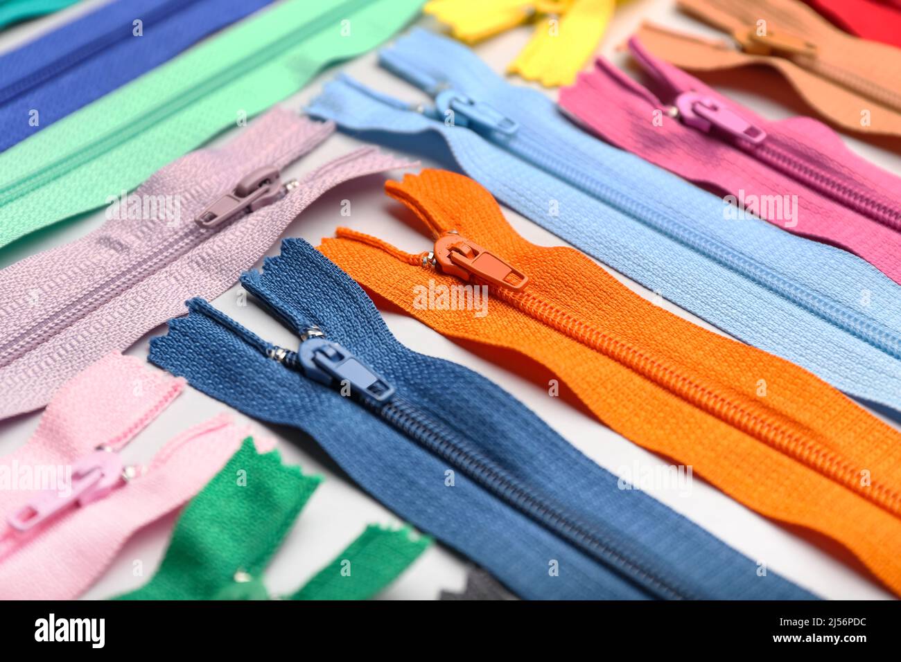 Stylish different zippers on light background, closeup Stock Photo - Alamy