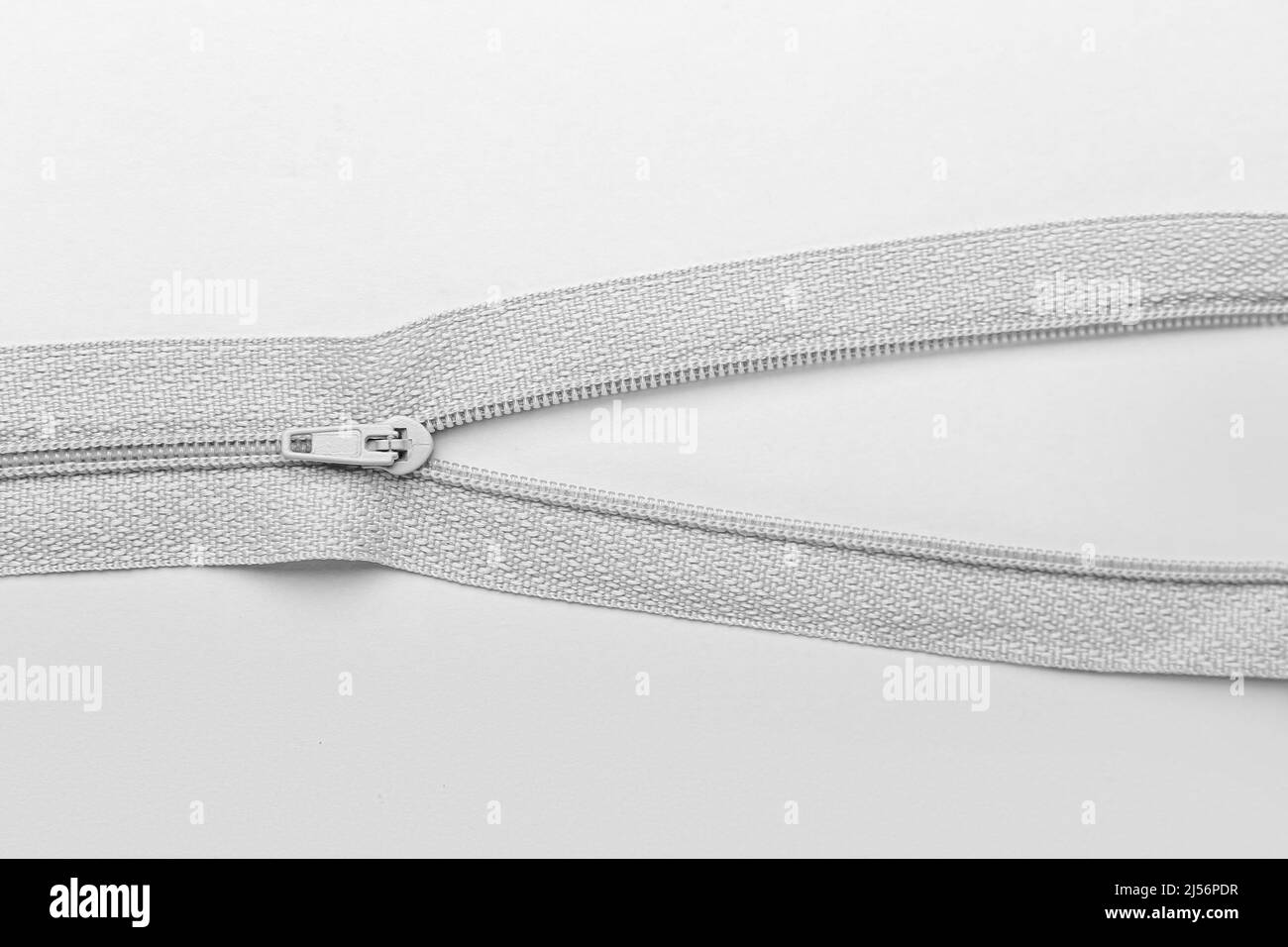 Stylish grey zipper on white background Stock Photo - Alamy