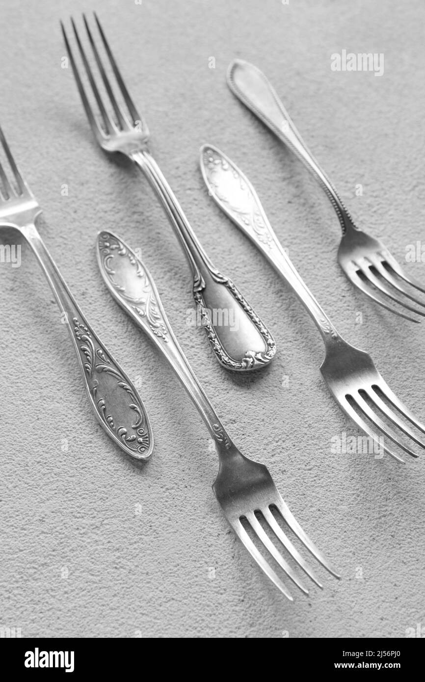 Silver forks on light background Stock Photo - Alamy