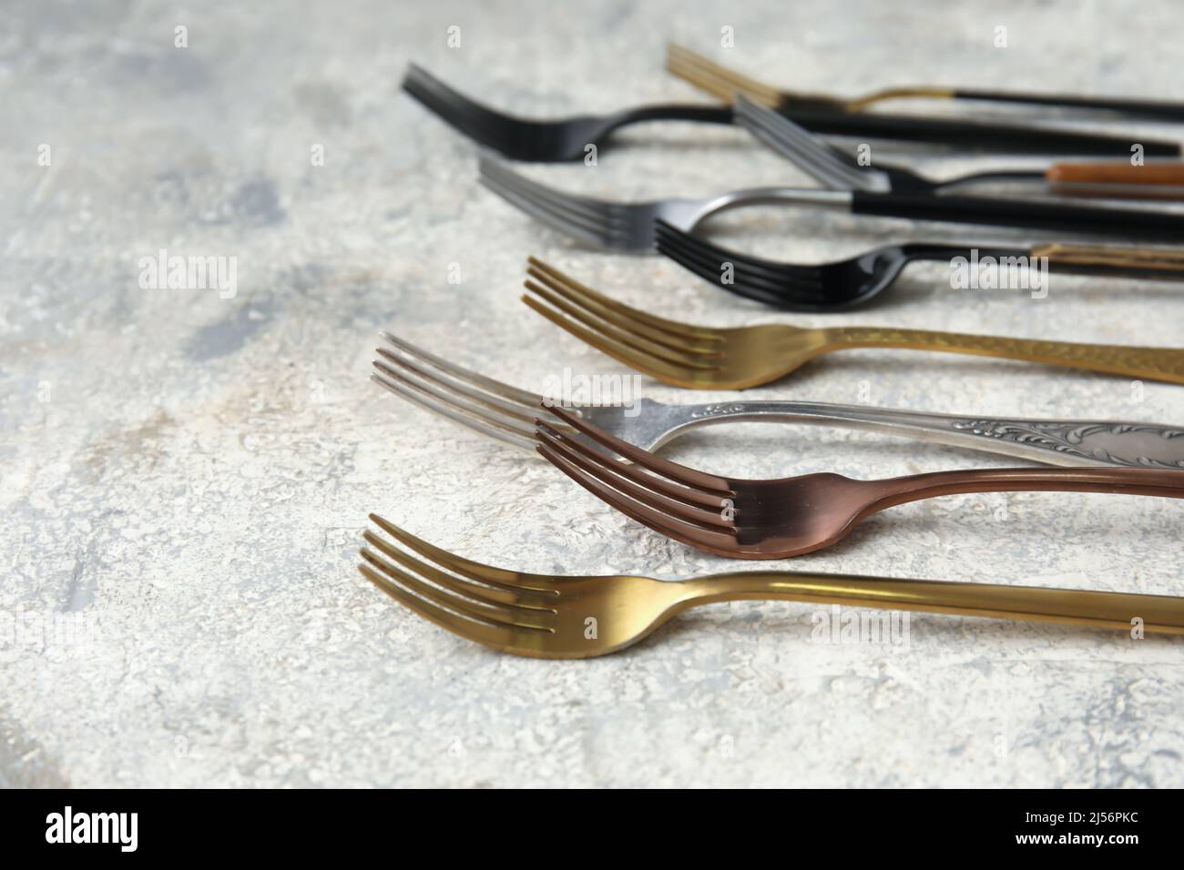 Many different forks on light background Stock Photo - Alamy