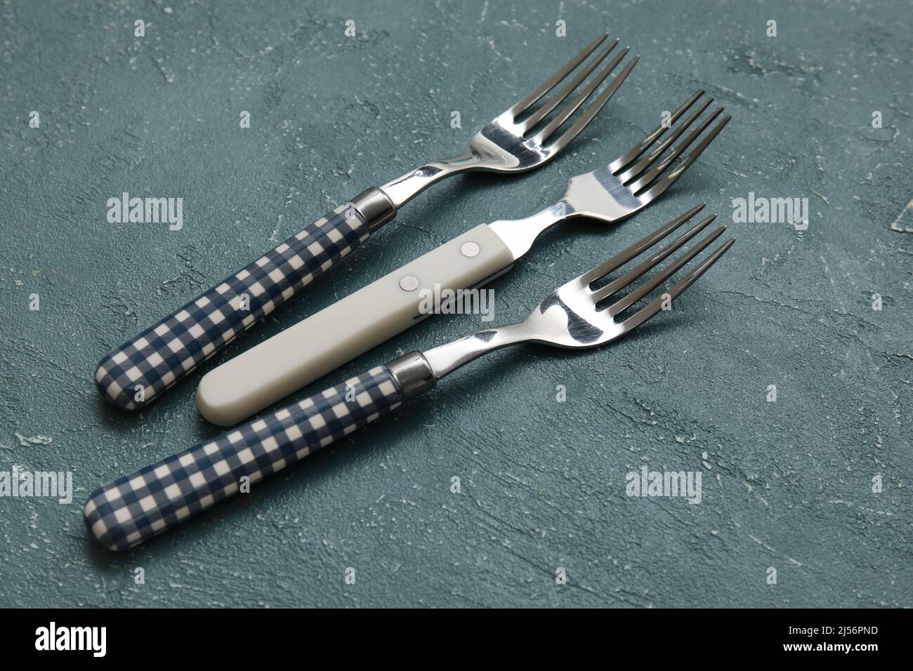 Different forks on grey background Stock Photo - Alamy