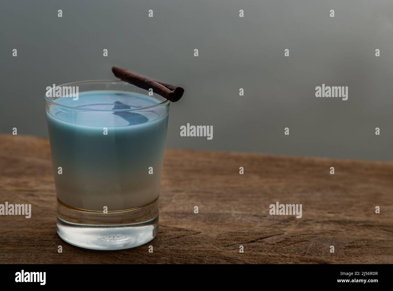 A glass of Blue matcha latte tea or Butterfly pea flower milk tea latte ...