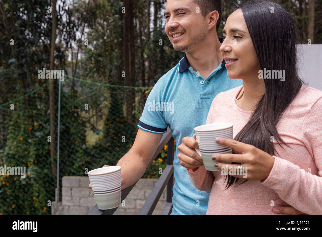 Smiling couple expecting a child look forward smiling optimistically in ...