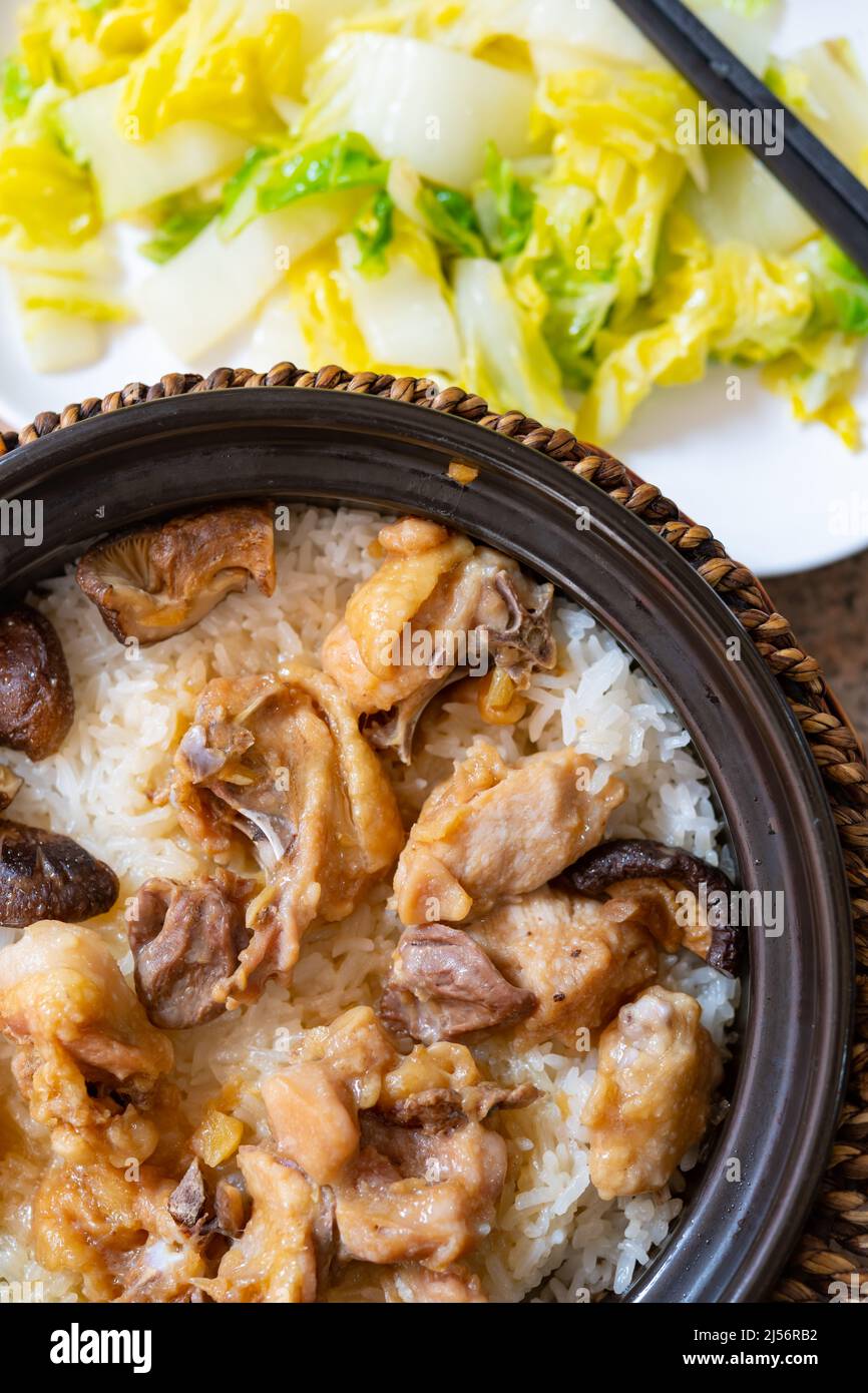 top view clay pot rice with chicken and mushrooms and cabbage at ...