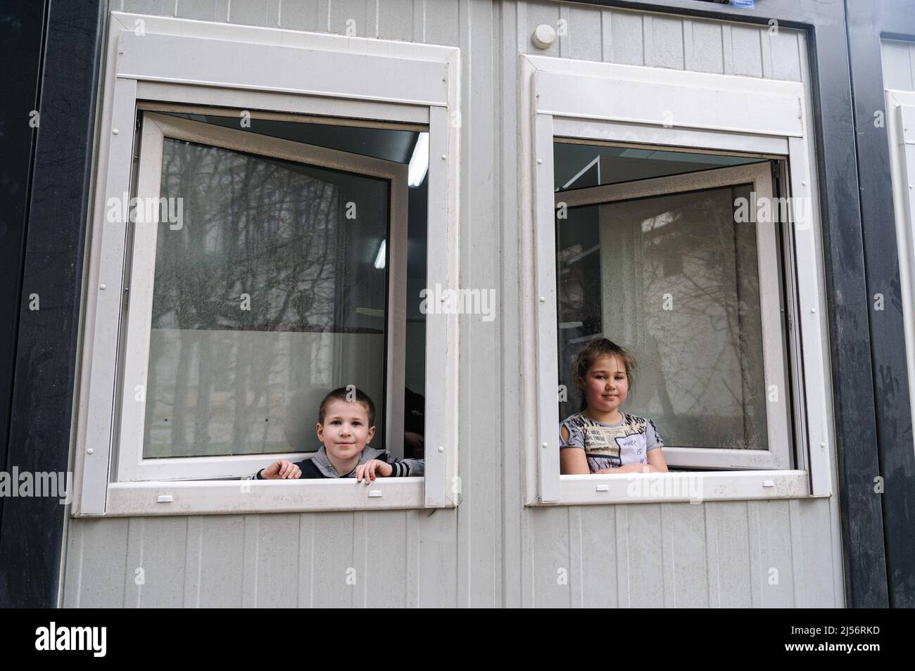 Ukrainian children seen looking outside of windows at the settlement ...