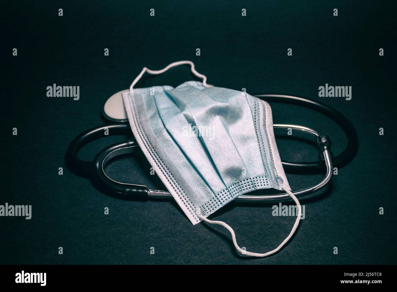 surgical mask and stethoscope on dark background with vignette Stock ...