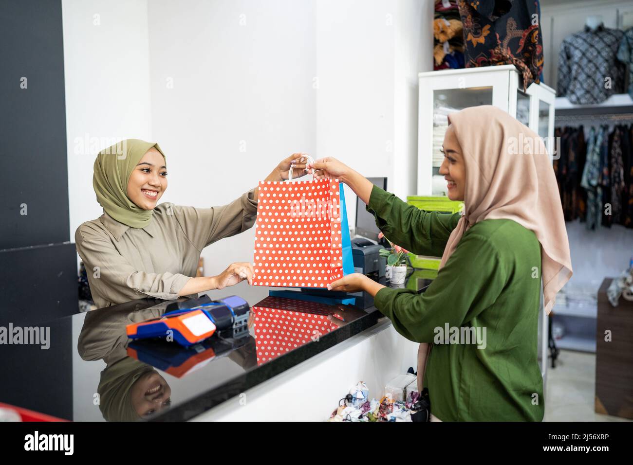 muslim cashier worker payment transaction at the checkout counter Stock ...