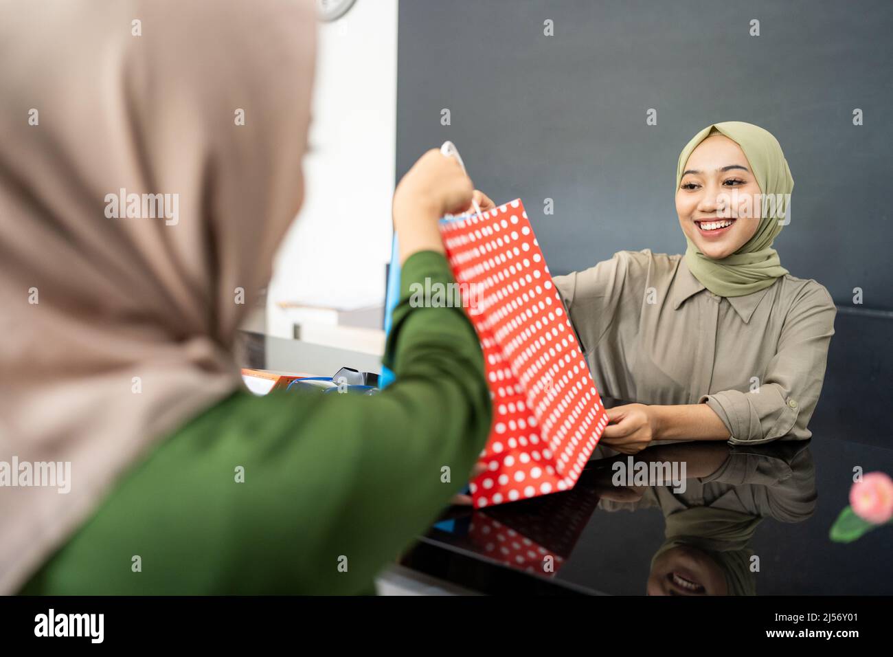muslim cashier worker payment transaction at the checkout counter Stock ...
