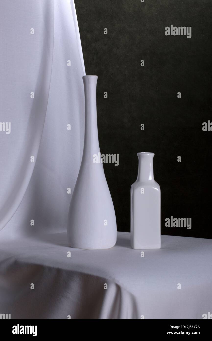 Still life with two white vases on white fabric Stock Photo - Alamy