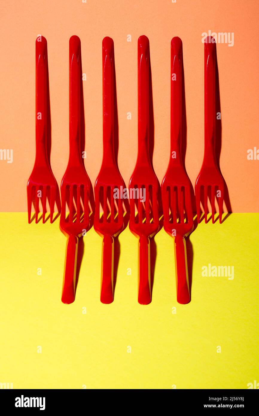 Abstract still life with red forks on a colored background Stock Photo ...
