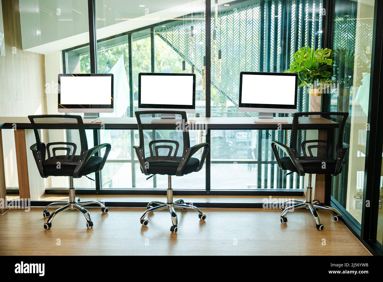 Workspace desk. Computer desktop blank screen in front of window in ...