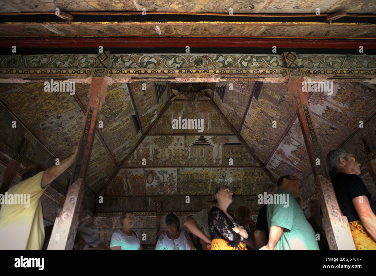 Tourists paying attention to the old Kamasan-style paintings on the ...