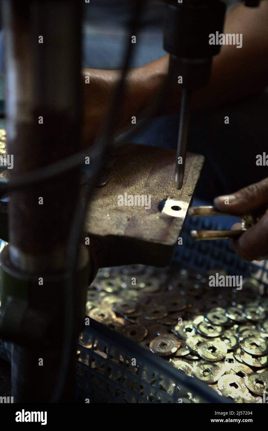 Production of traditional Balinese coins with hollow known as "pis ...