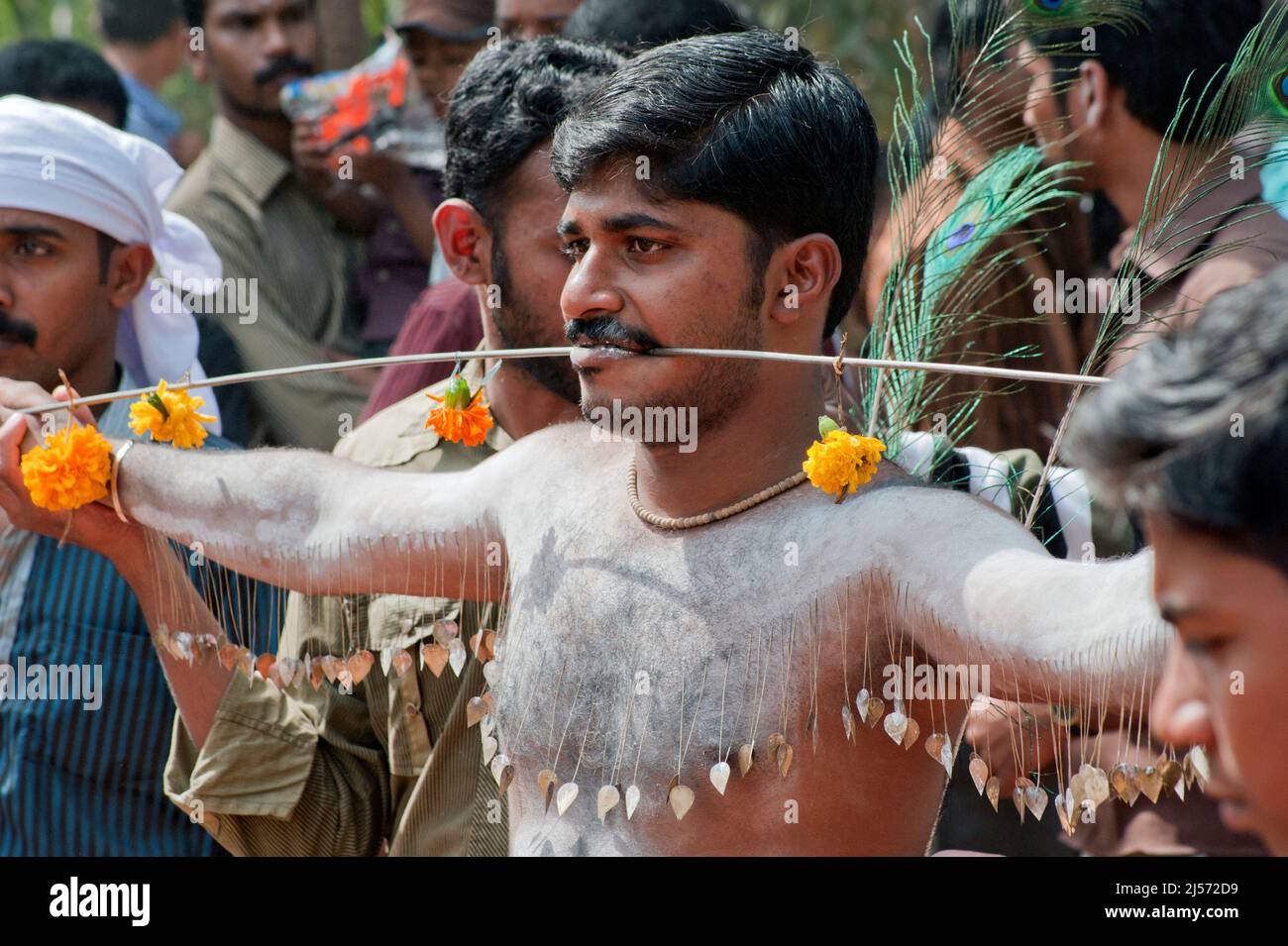 Man piercing spikes through cheeks discharging vow in Thaipusam ...