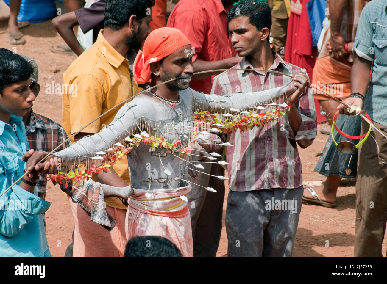 Man piercing spikes through cheeks discharging vow in Thaipusam ...