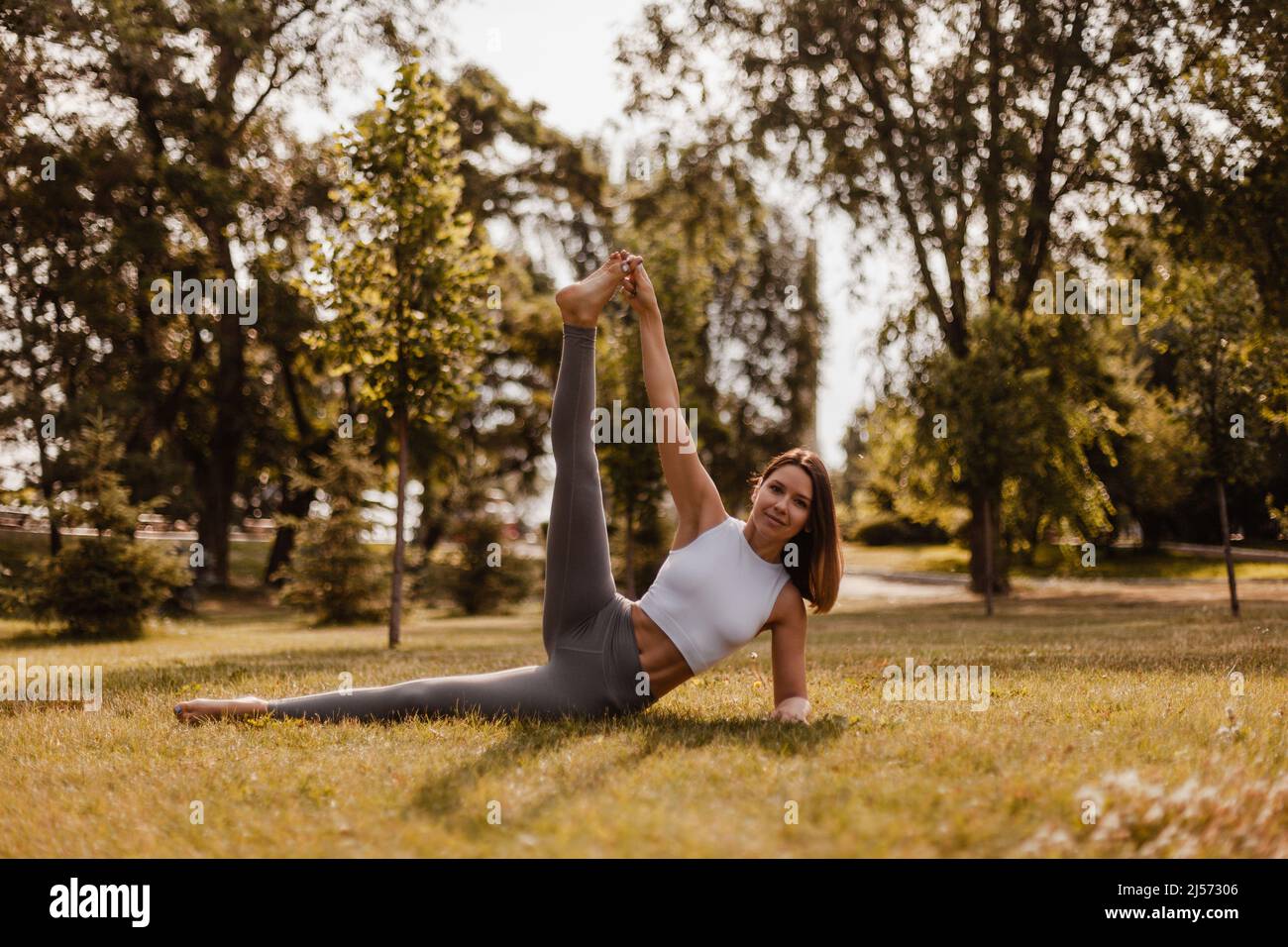 full length yoga concept. sporty woman sit in yoga stretching position ...