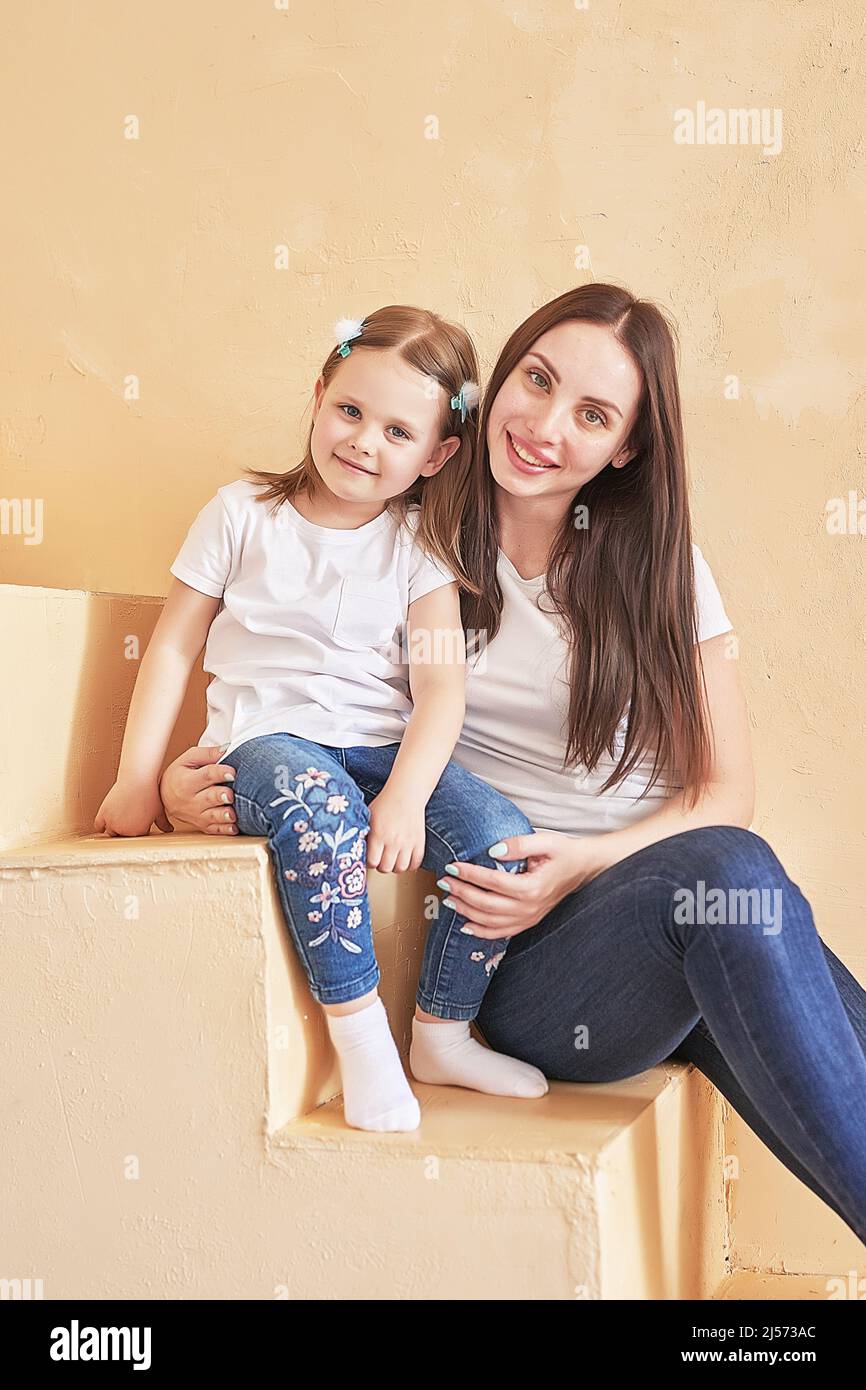 Happy family. Mother and daughter at home. Young woman and girl. Mothers and childrens day. Good ...