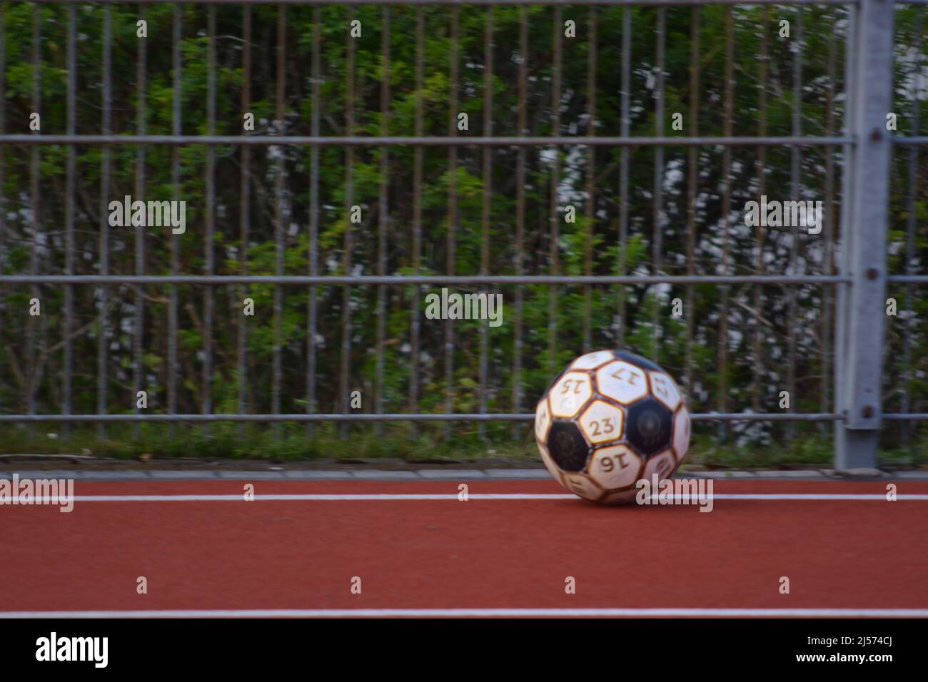 Soccer ball football flying over a sports court with yellow and red ...
